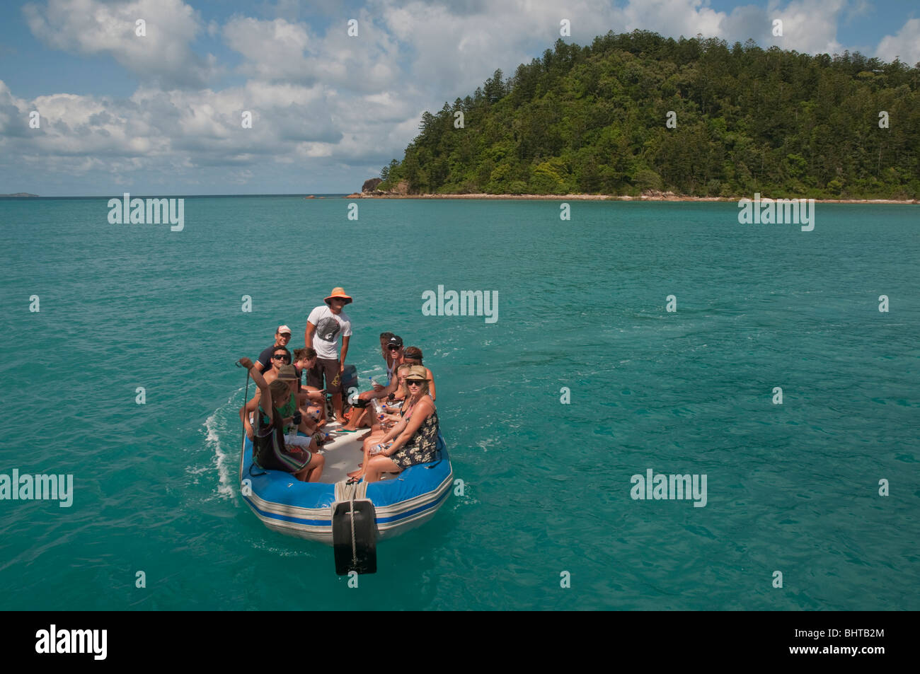 Tourists in dinghy in the Whitsunday Islands off the Queensland coast ...