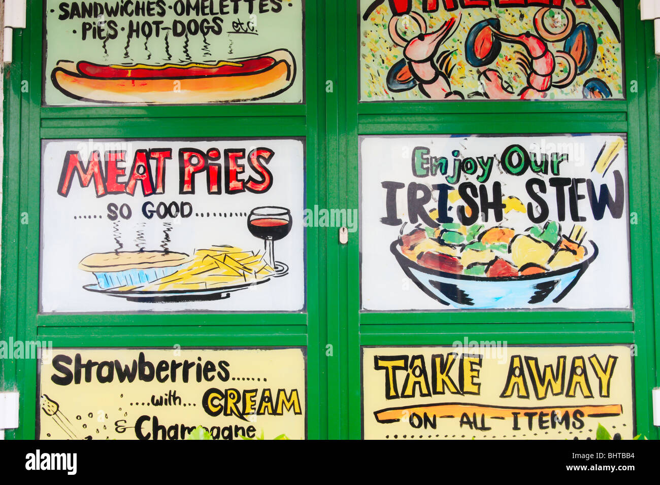 Menu painted on window of Irish bar in Spain Stock Photo - Alamy