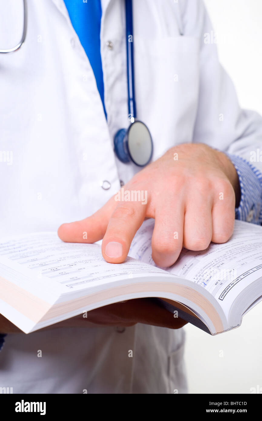male doctor with stethoscope reading medical book Stock Photo - Alamy