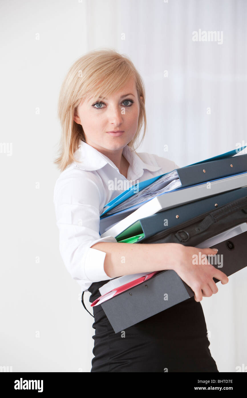 busy business woman carrying files and folders Stock Photo - Alamy