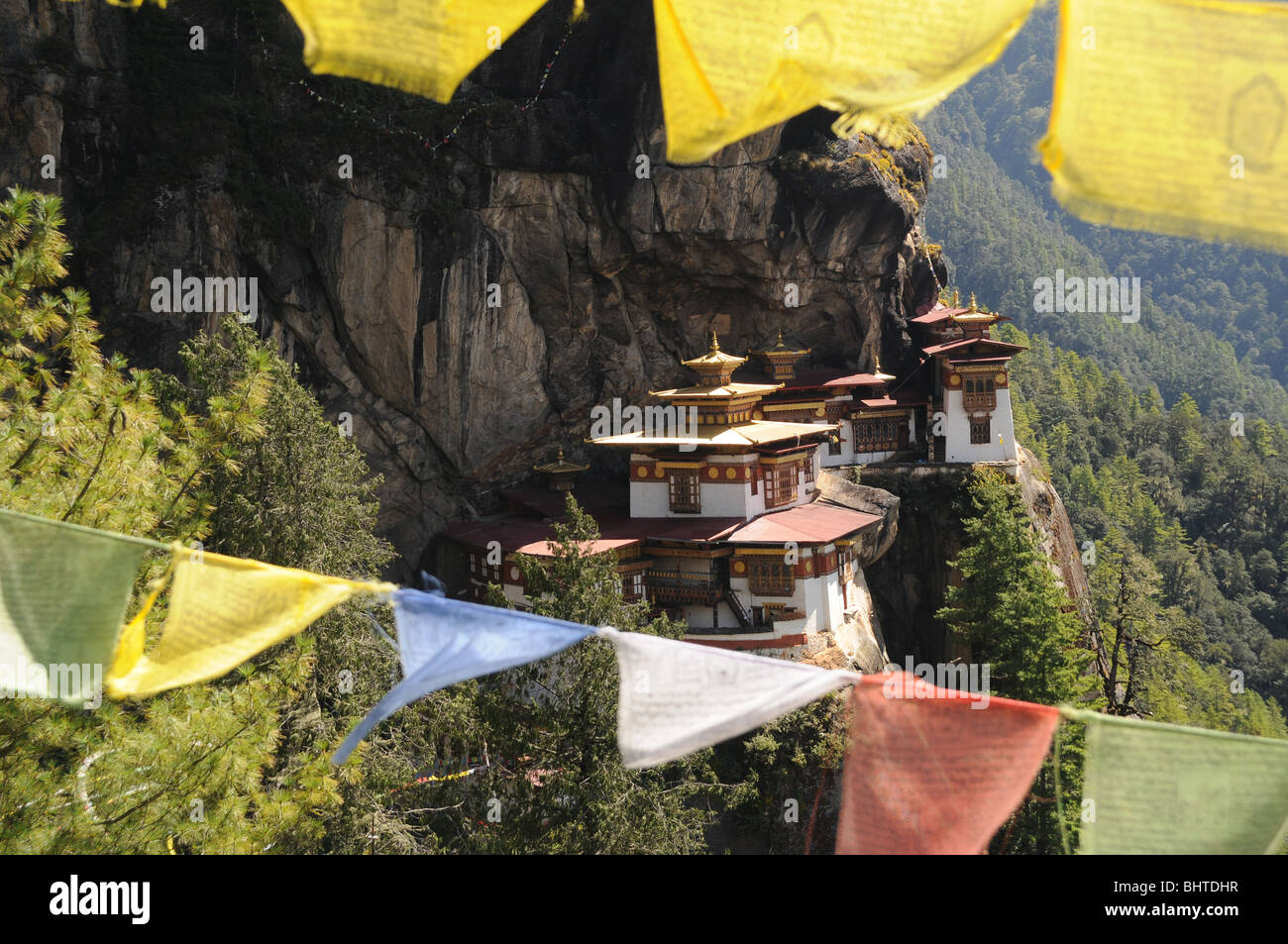 temple on a cliff face with prayerflags Stock Photo - Alamy
