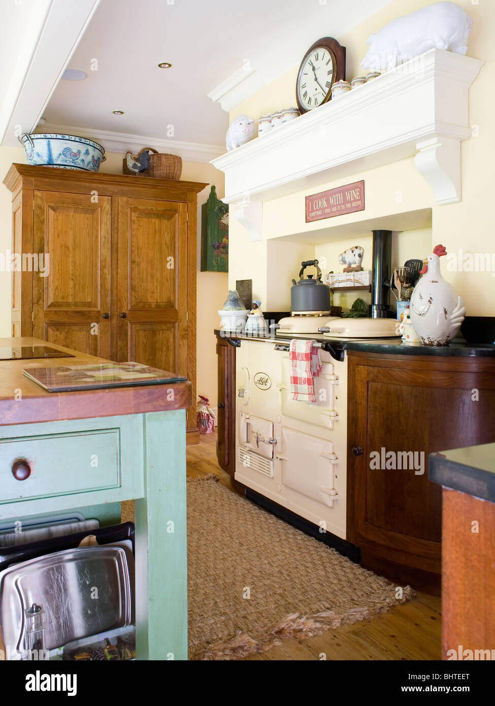 Cream Aga oven in country kitchen with large wooden cupboard Stock ...