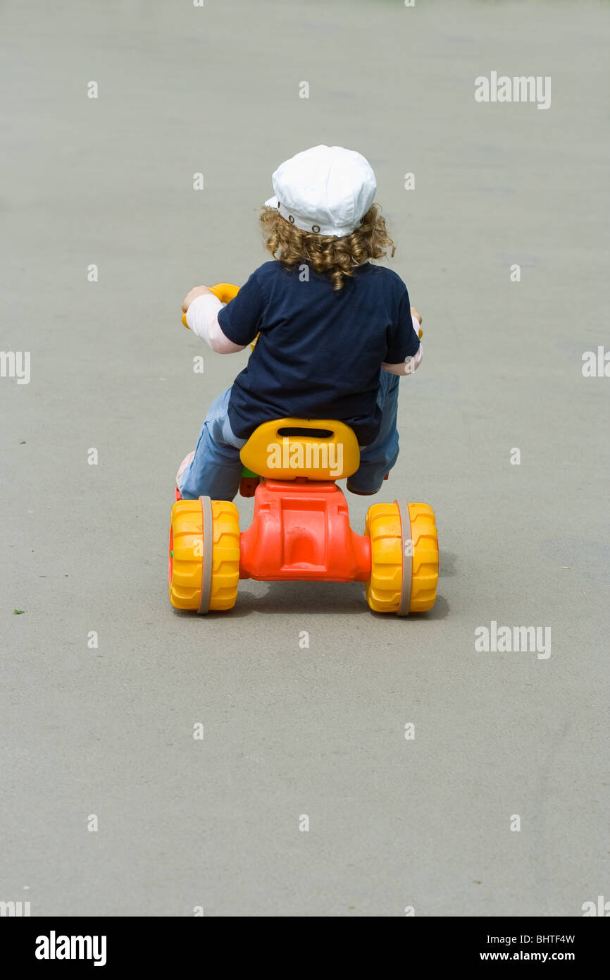 Boy riding a tricycle hi-res stock photography and images - Alamy