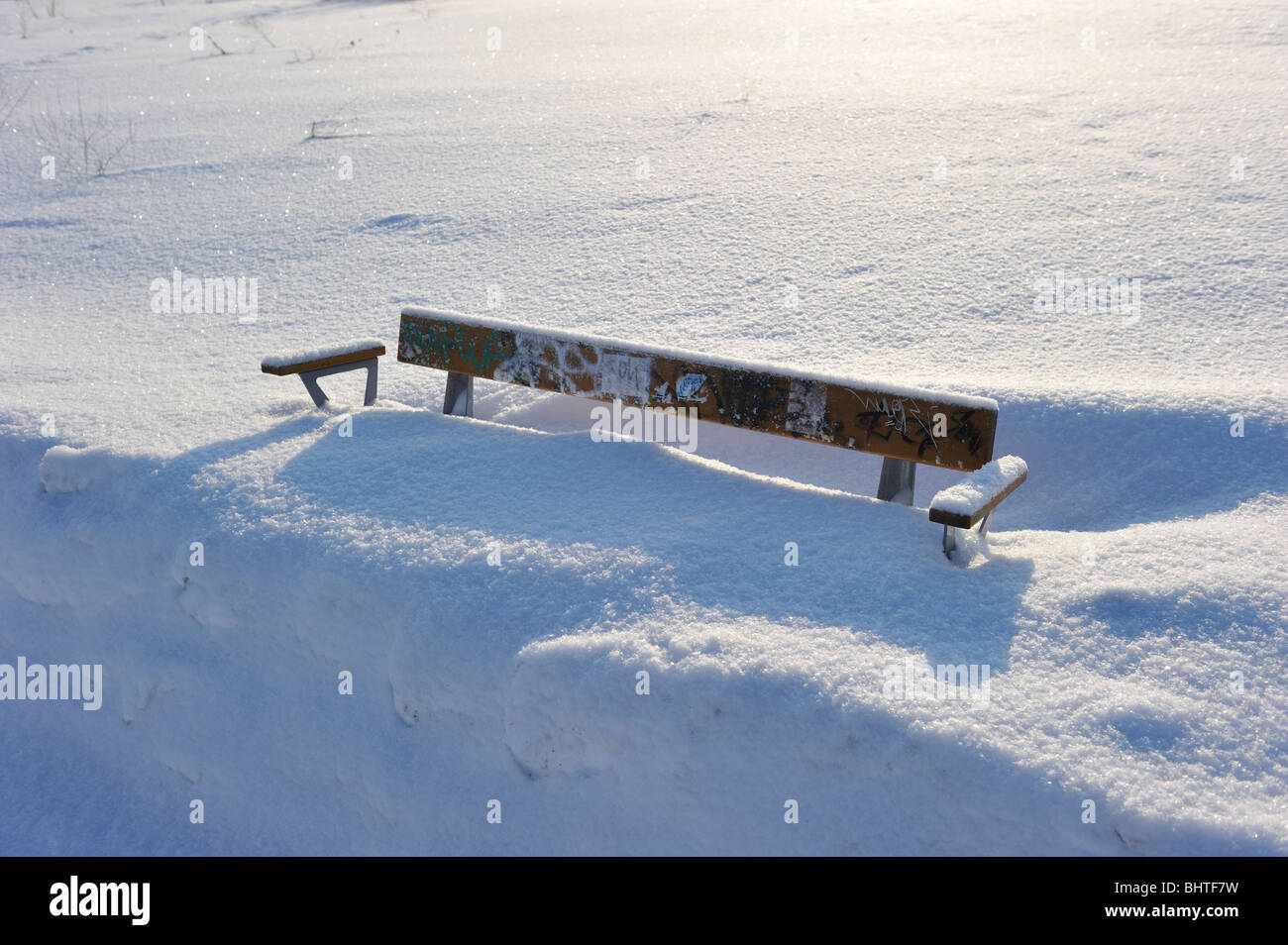 Over snowed bench by a park way Stock Photo - Alamy