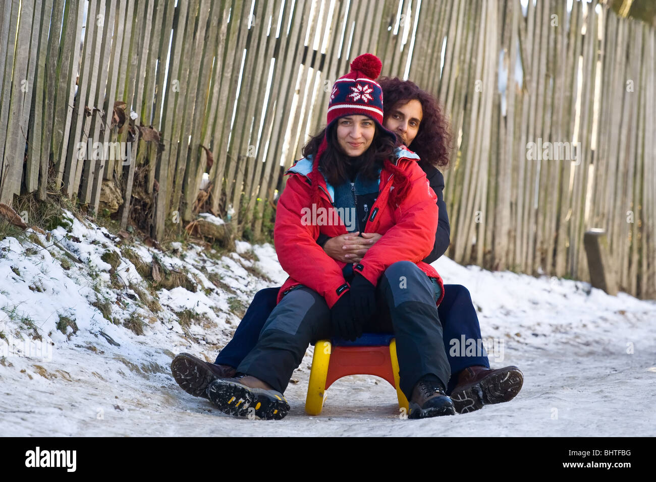 Two women on sled Stock Photo - Alamy