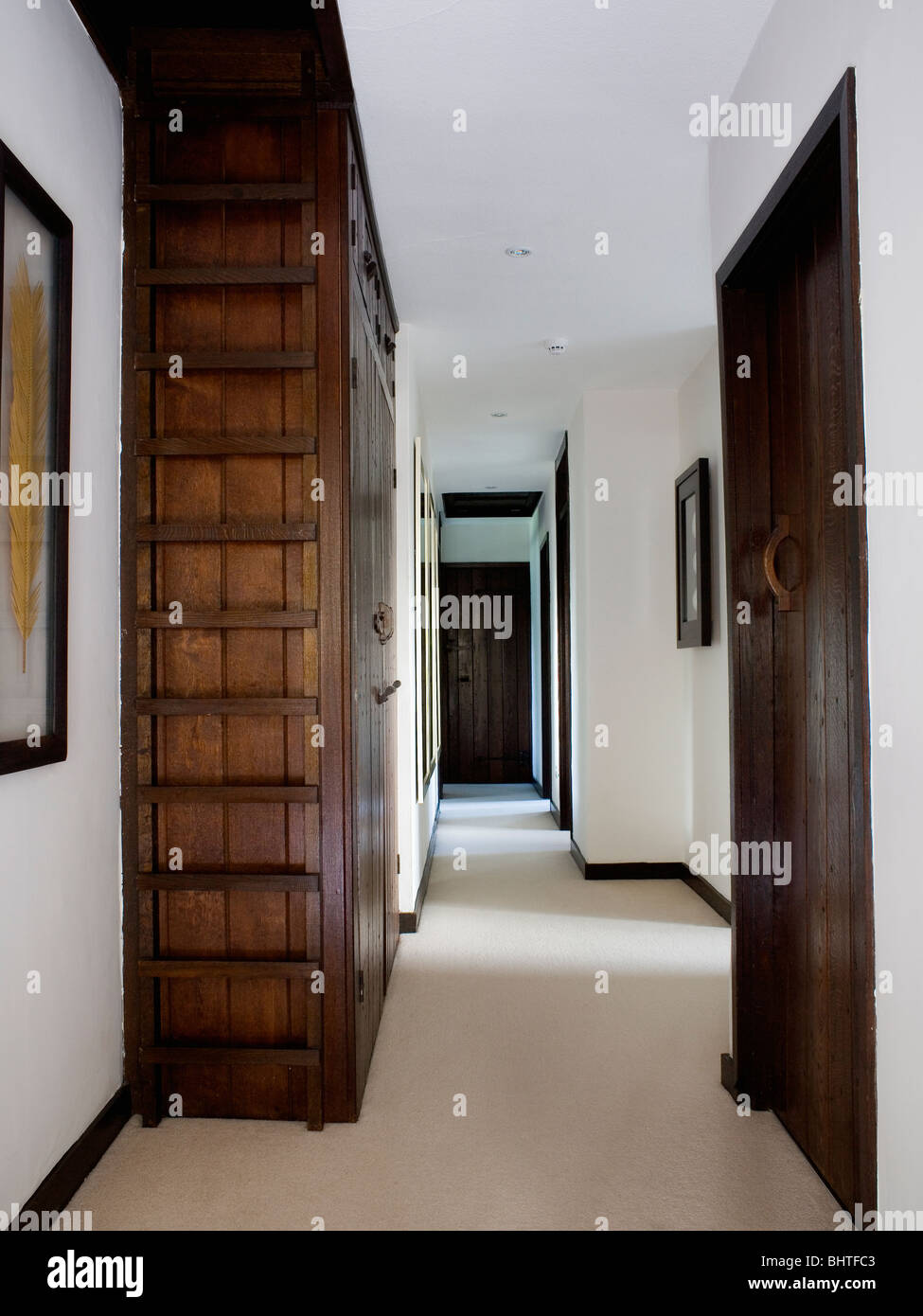 Sideways view of modern hall corridor with large carved oak cupboard ...
