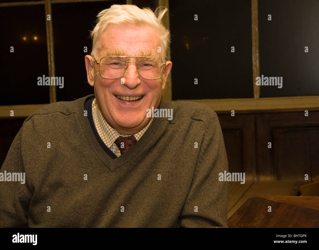 Silver haired older man beams happily at the camera Stock Photo - Alamy