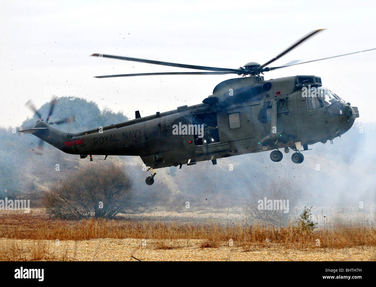 Royal Navy Sea King helicopter dropping off troops, taking off, landing ...