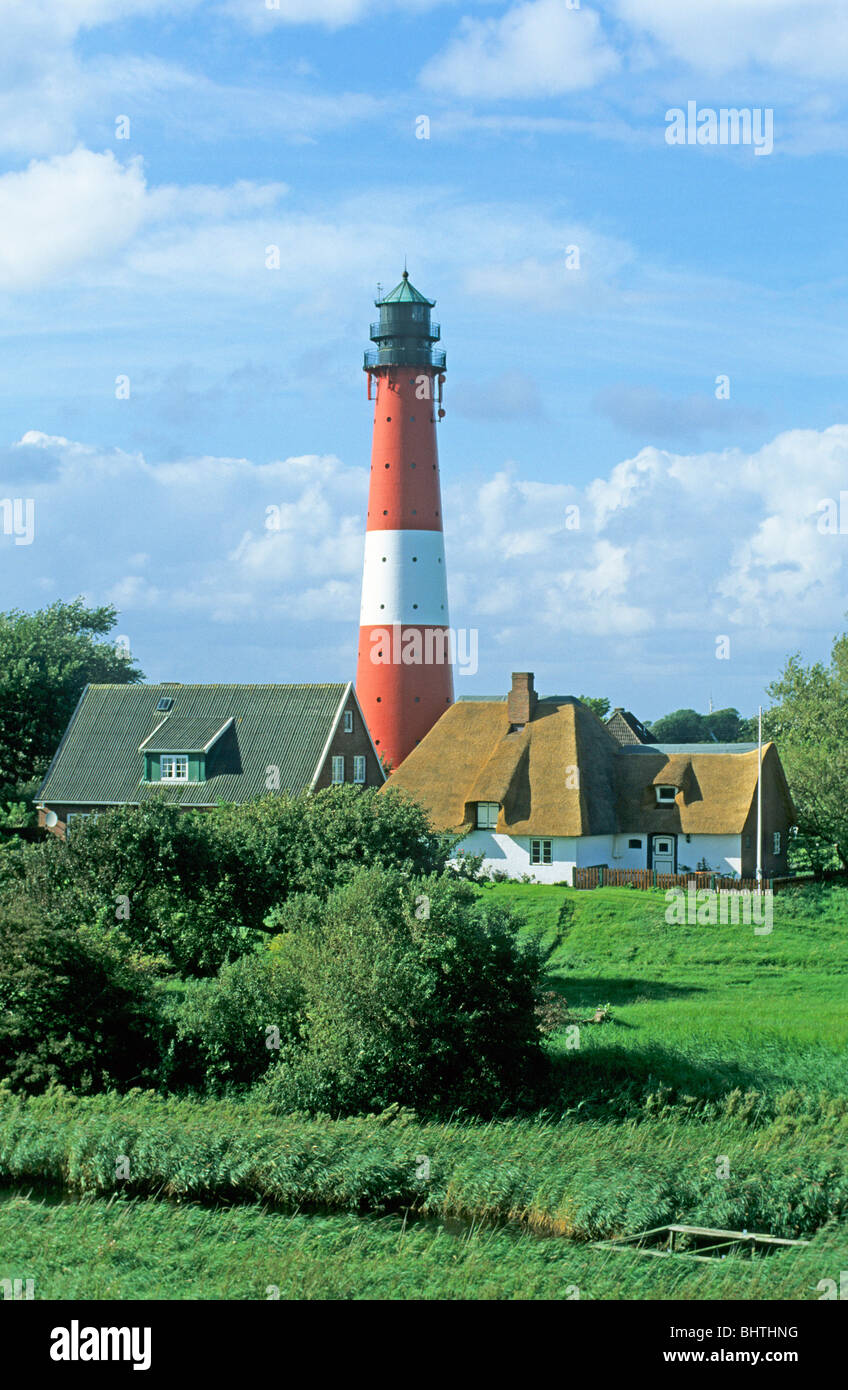lighthouse and thatched house on Pellworm Island, North Friesland ...