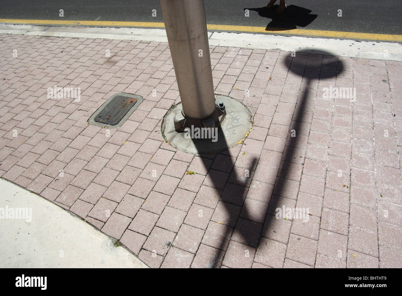 Pavement with pole's shadow Stock Photo - Alamy