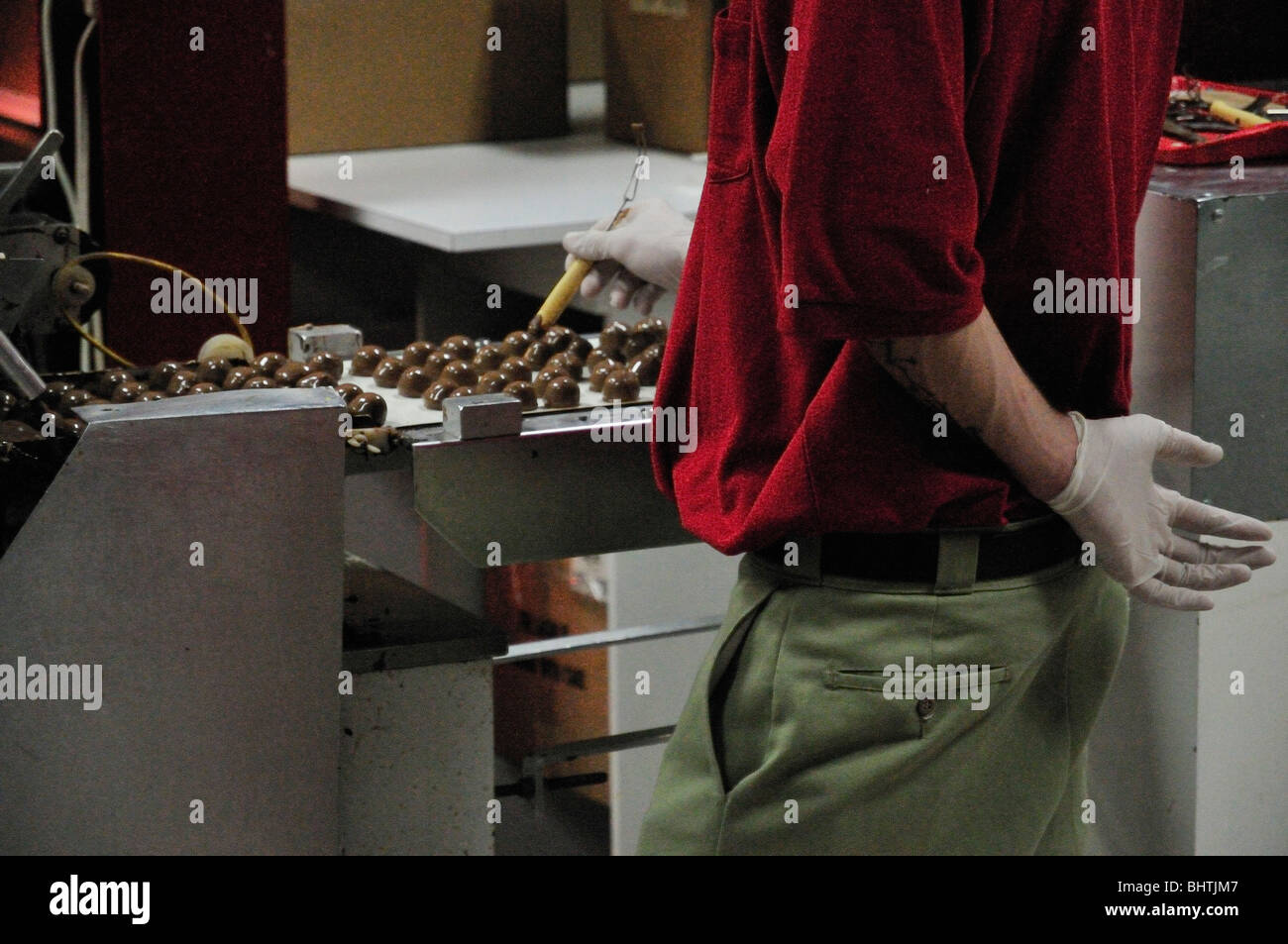 A candy maker decorates chocolate covered maple candies at the Angell ...