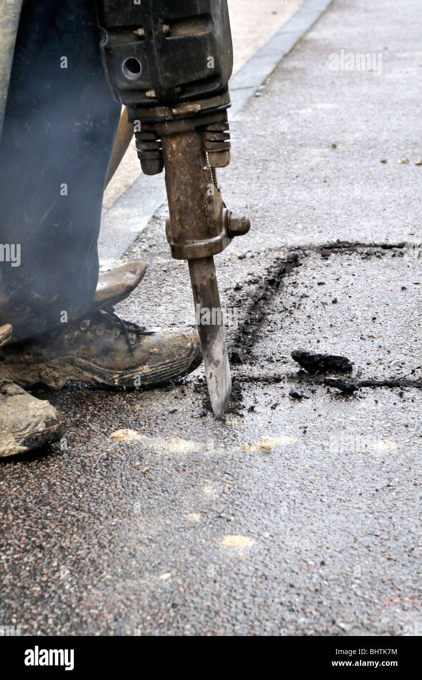 Digging up the pavement to replace gas pipe Stock Photo - Alamy