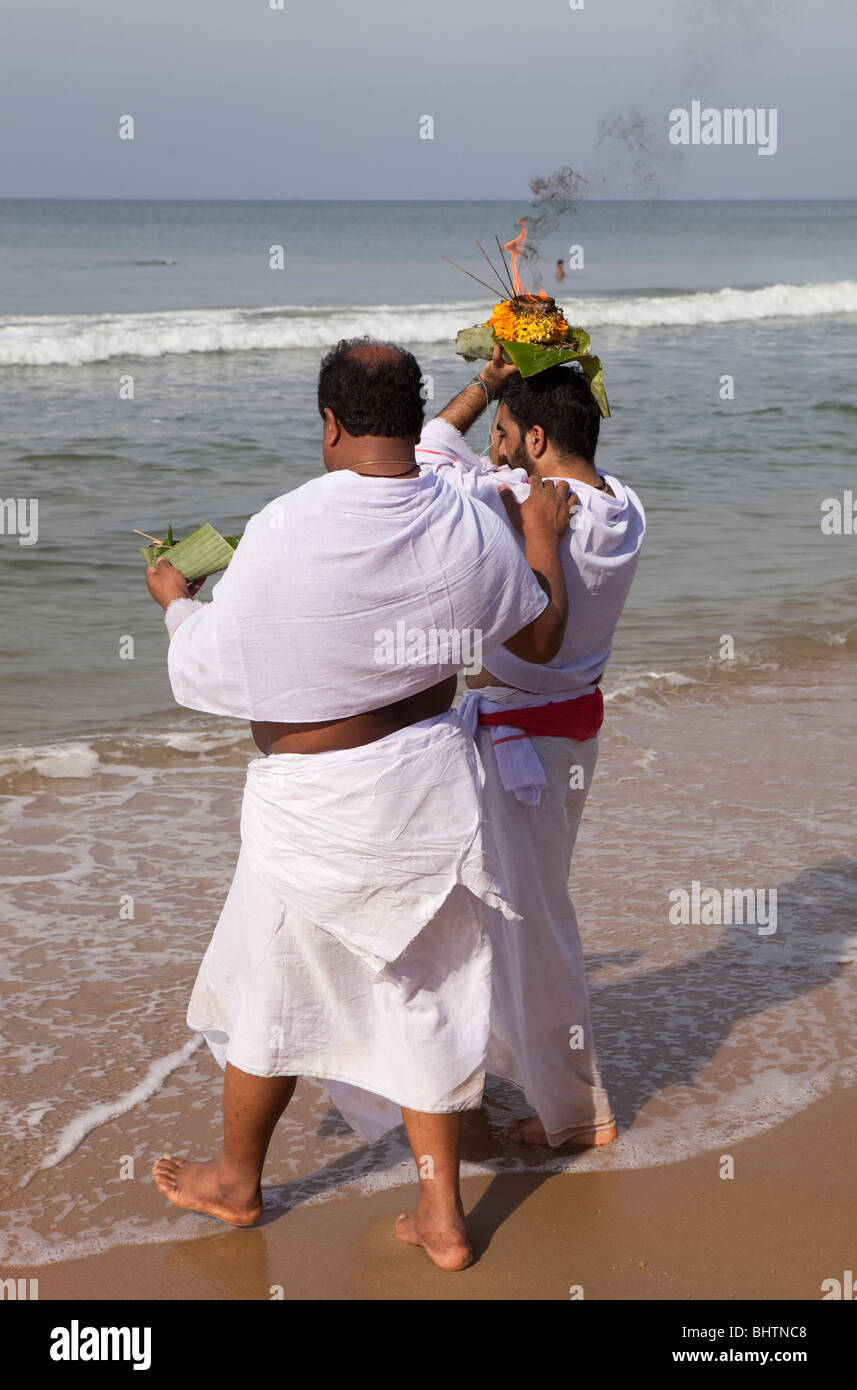 India, Kerala, Varkala beach, early morning, Indian pilgrim performing ...