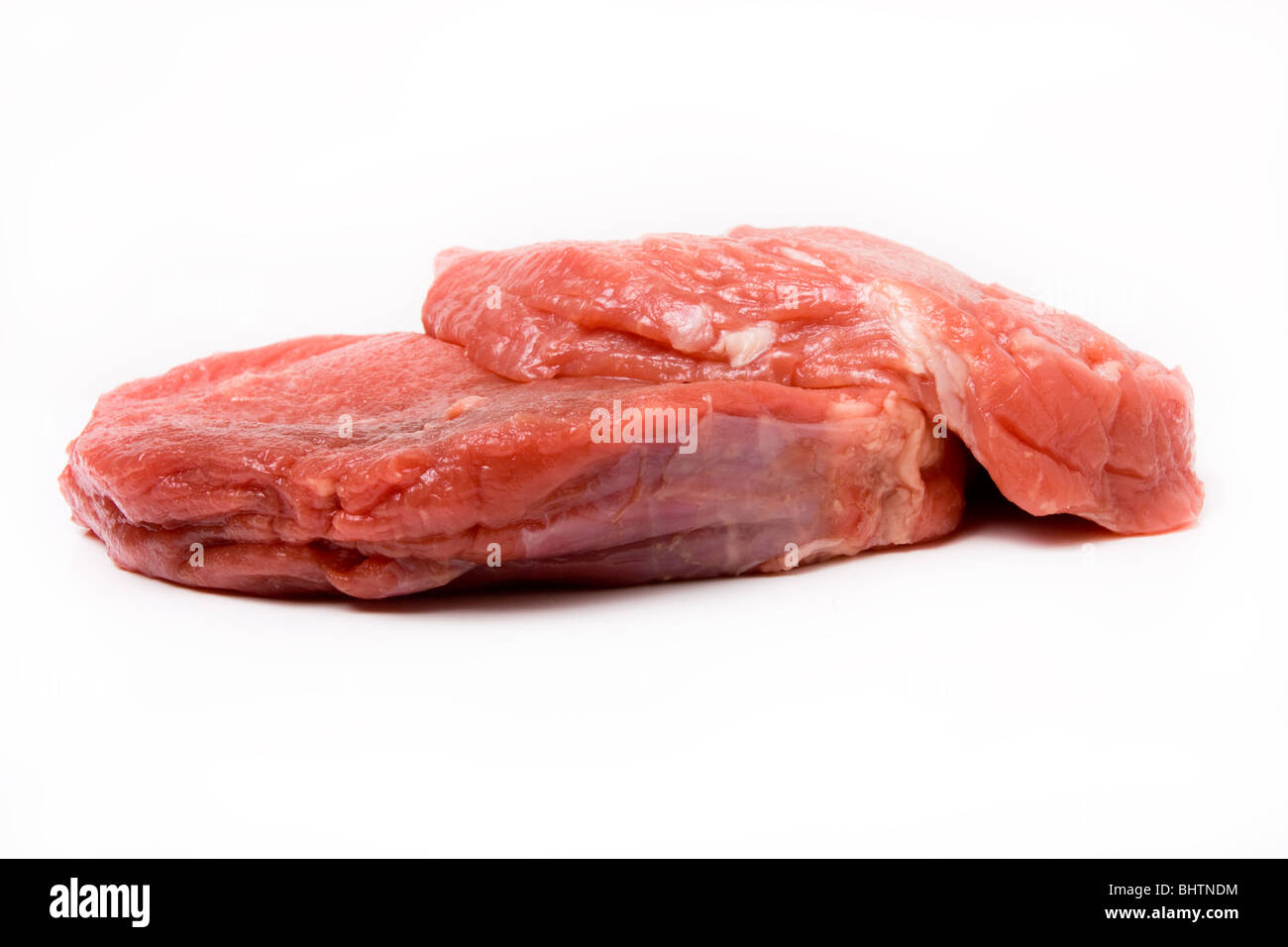 Heap of Raw Beef isolated against white background from low viewpoint ...