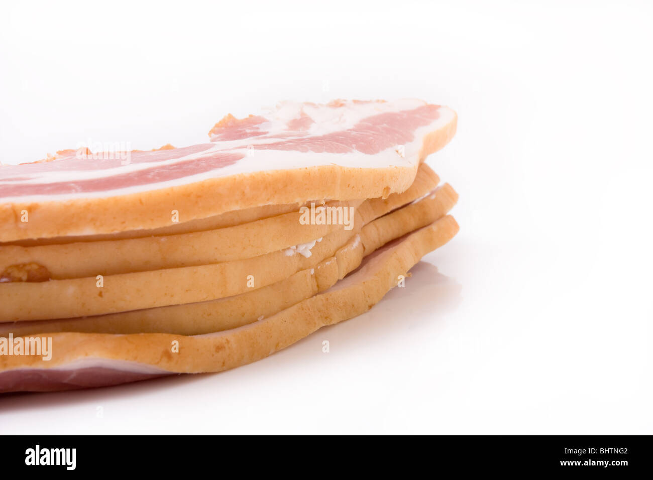 Pile of raw uncooked Sliced bacon isolated against white background ...