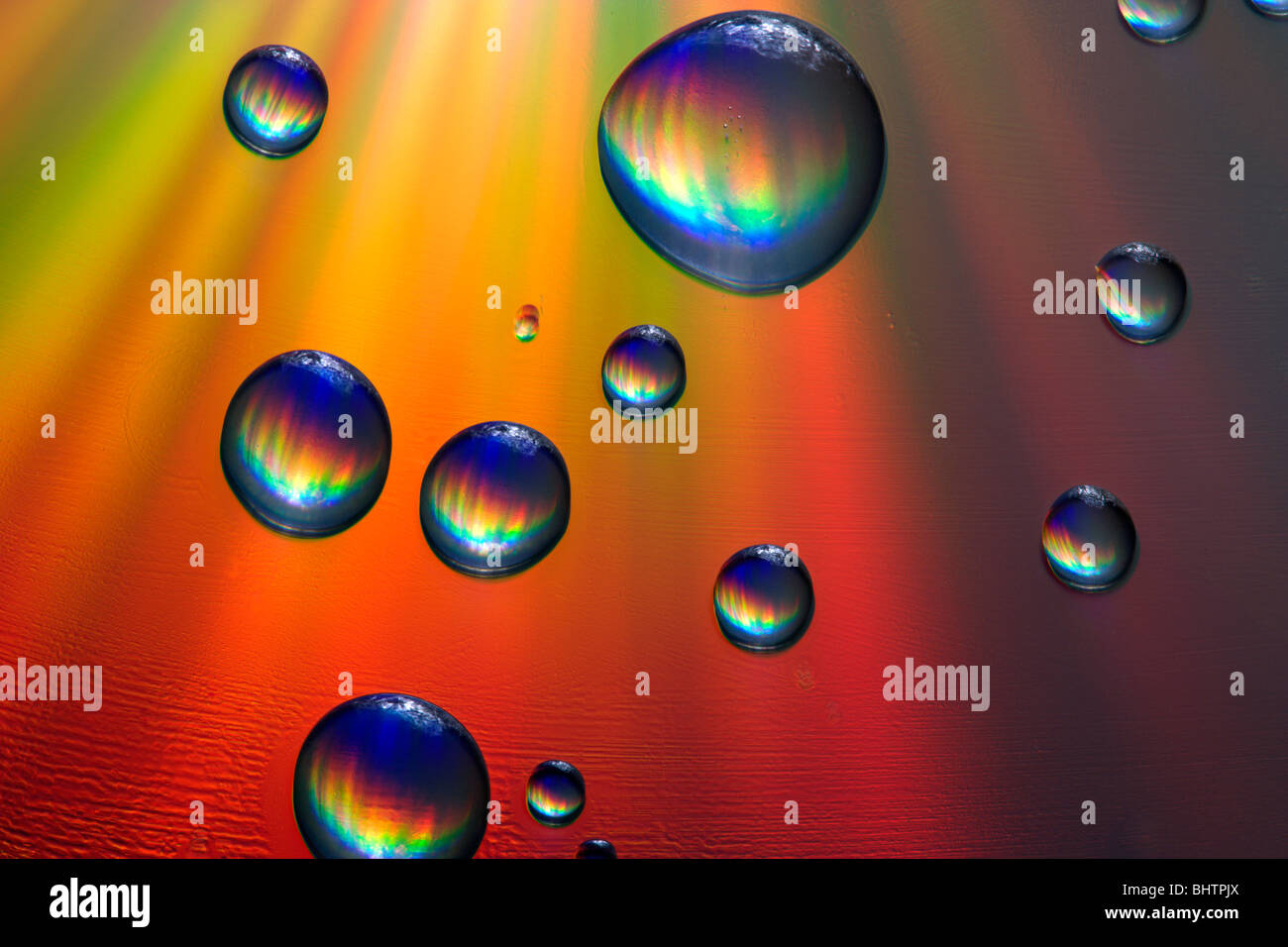Abstract of droplets of water on a colourful background (flash-lit DVD ...