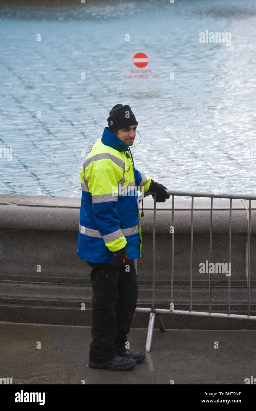 A security staff steward by a Trafalgar Square fountain officiating at ...