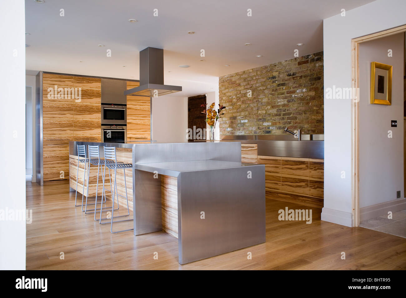 Large modern kitchen with stainless-steel surround on fitted unit and ...