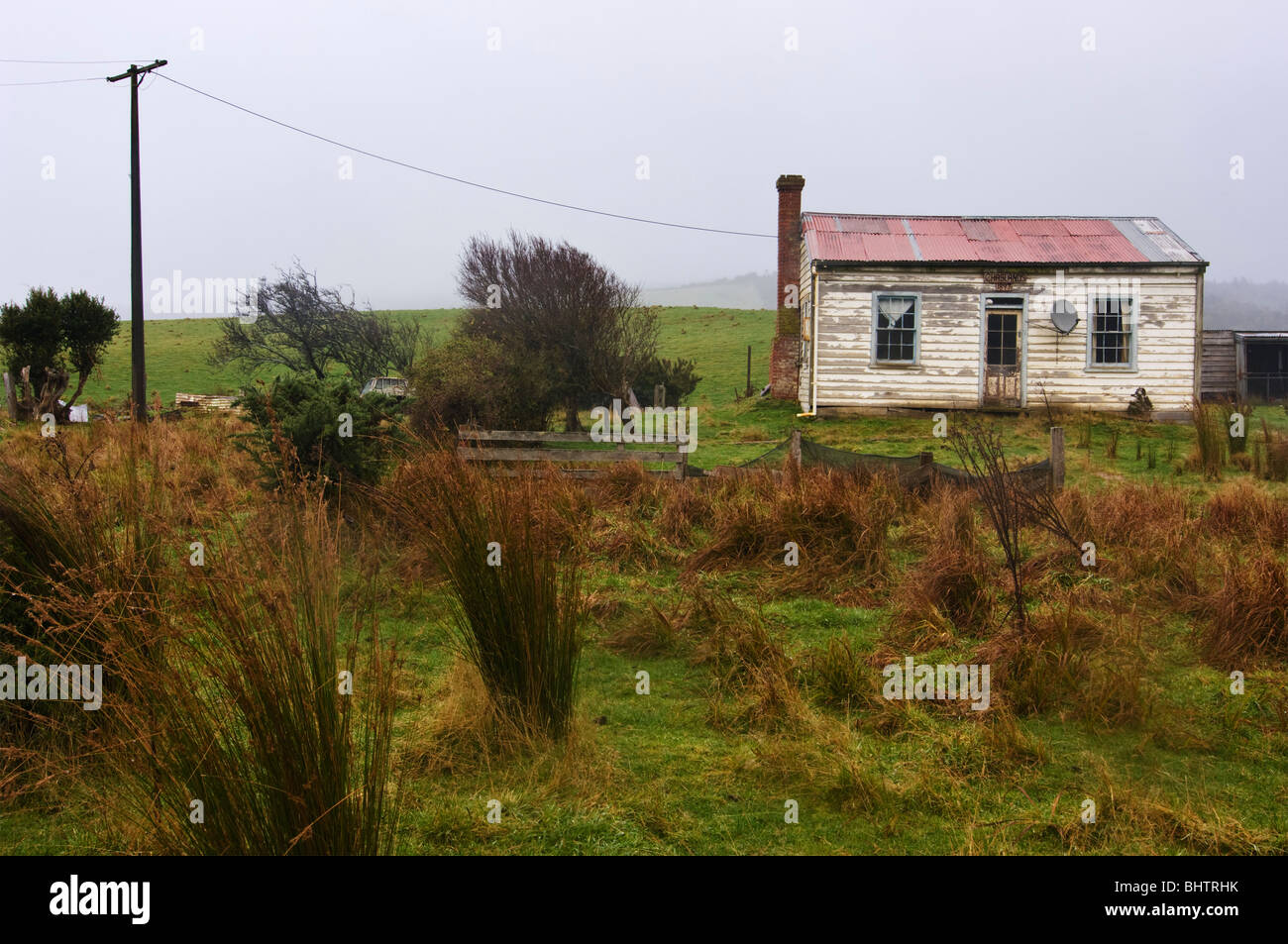 A rundown cottage in isolated countryside with an out of place ...