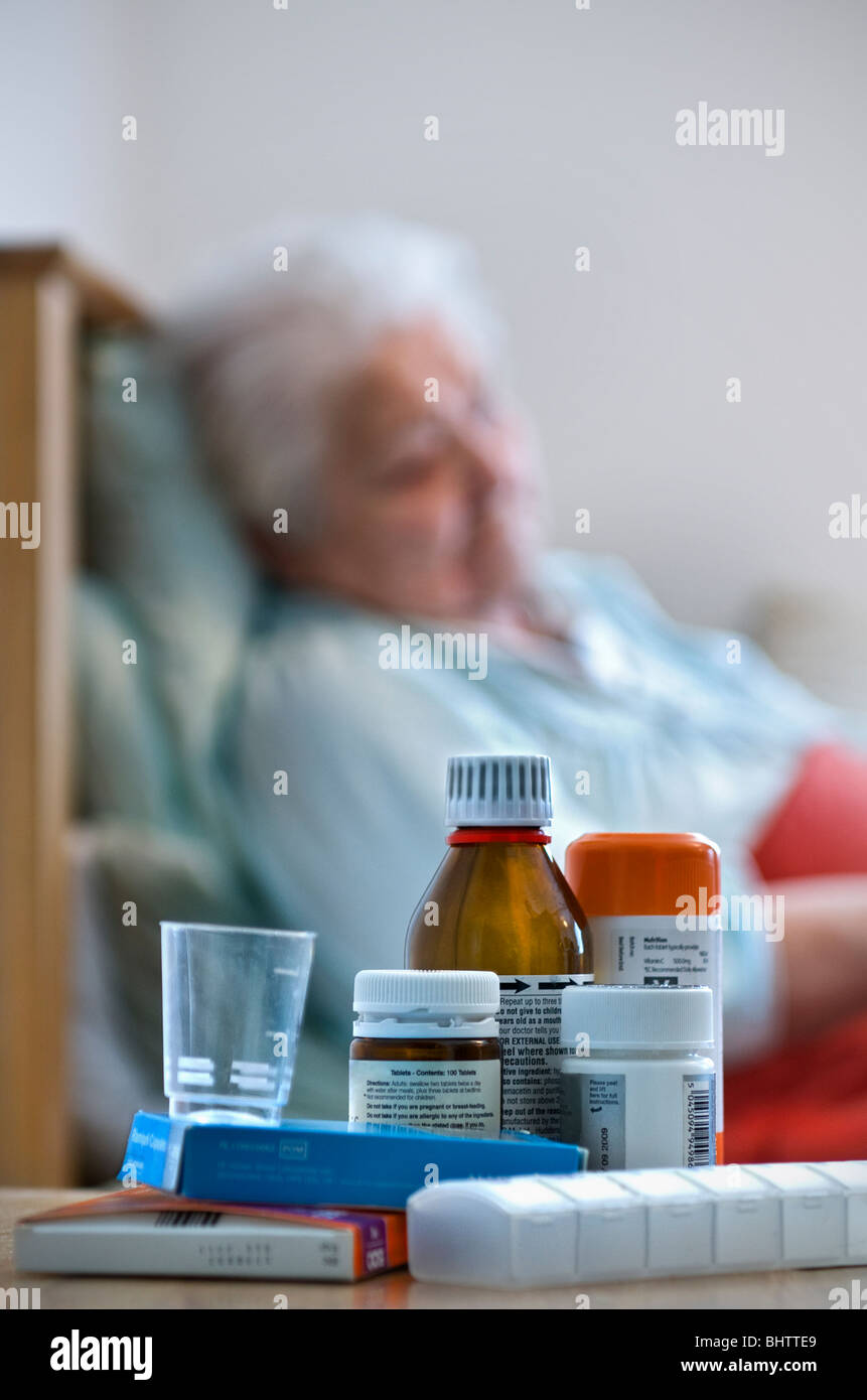 CORONAVIRUS covid-19 elderly lady resting ill in bed in her room with a ...