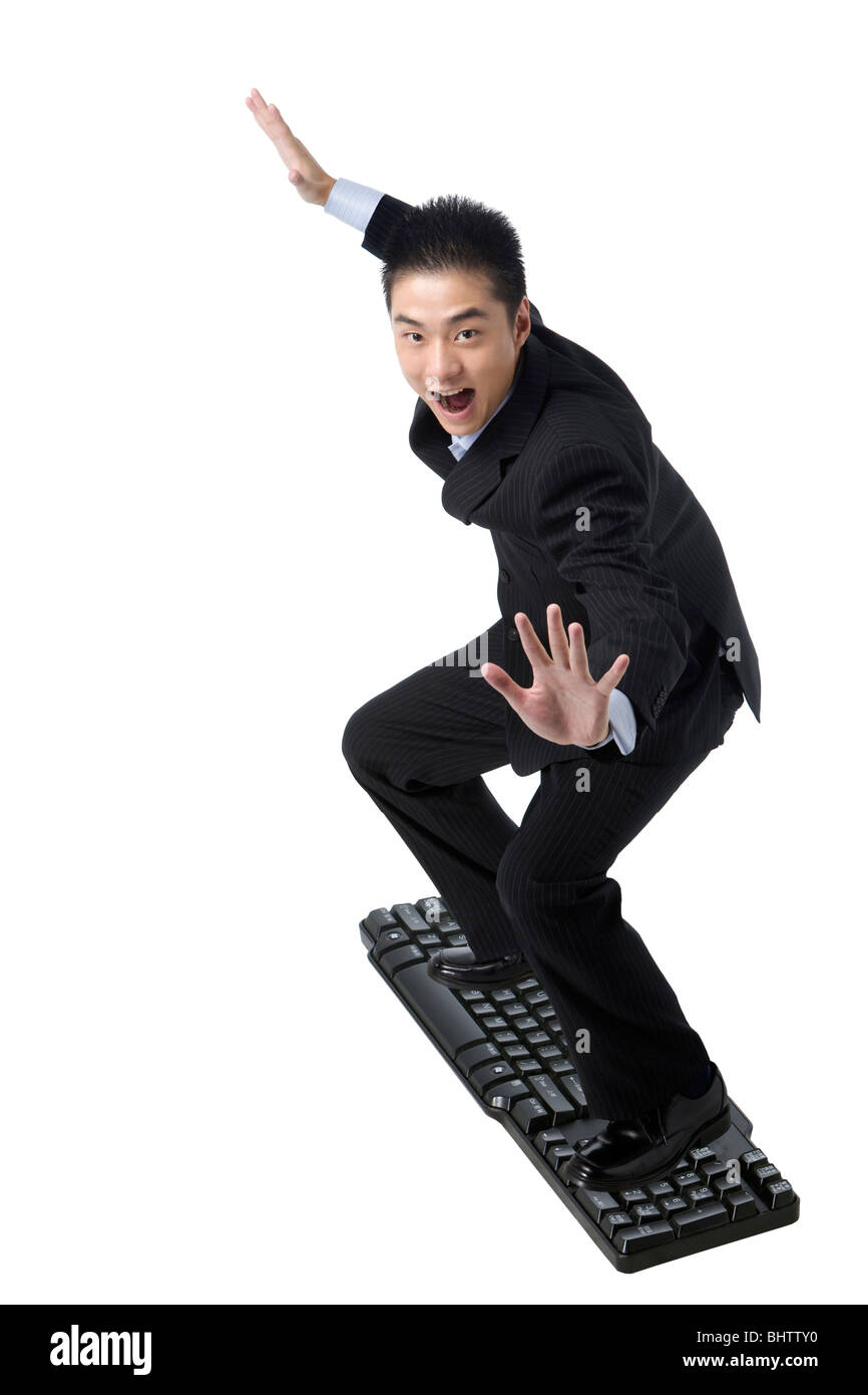 Businessman surfing on keyboard Stock Photo - Alamy