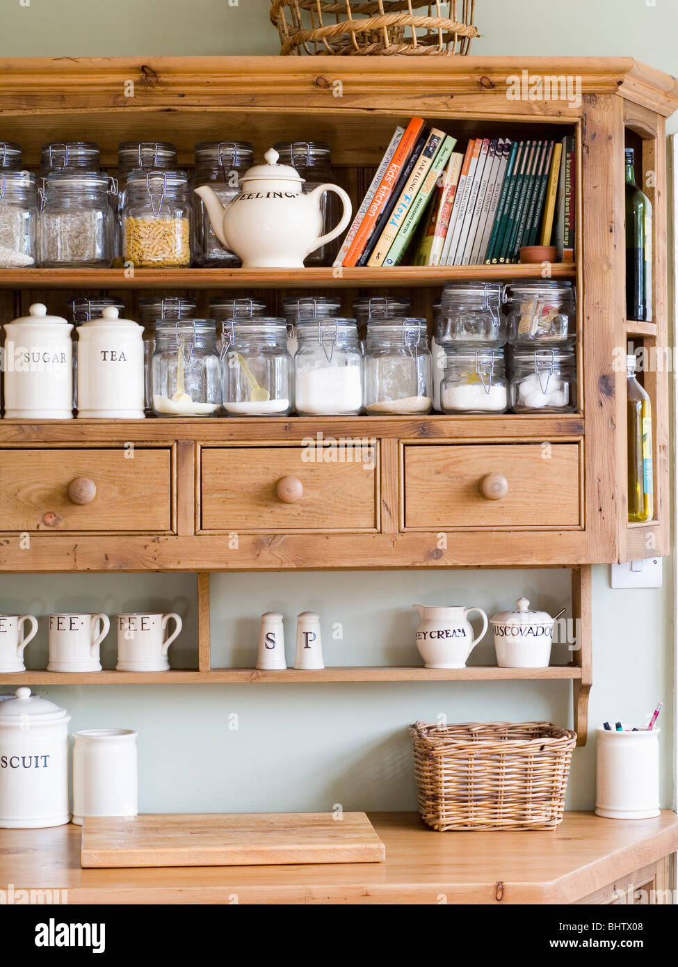 Close-up of storage jars on fitted pine wall cupboard with small ...