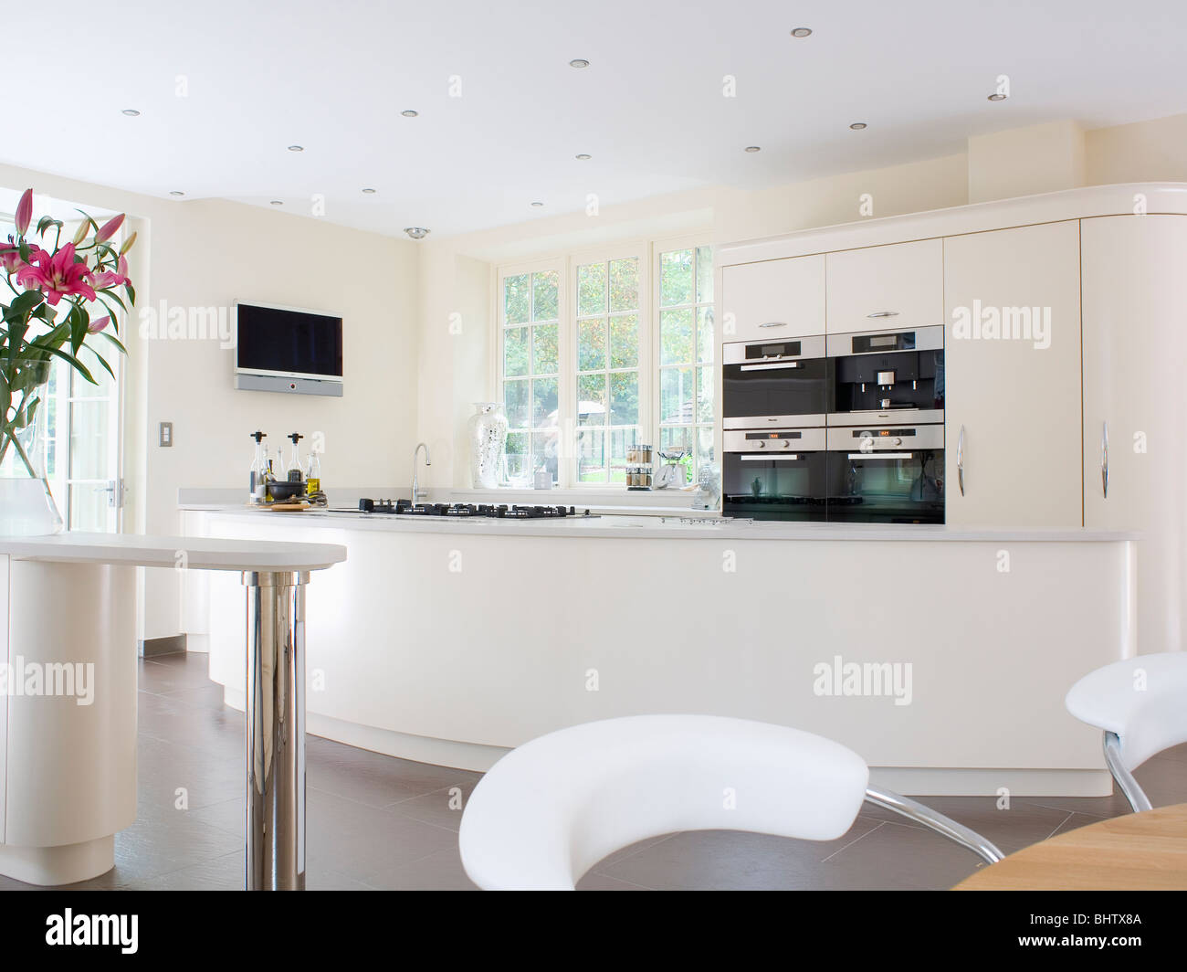 Large modern white country kitchen with curved island unit Stock Photo ...