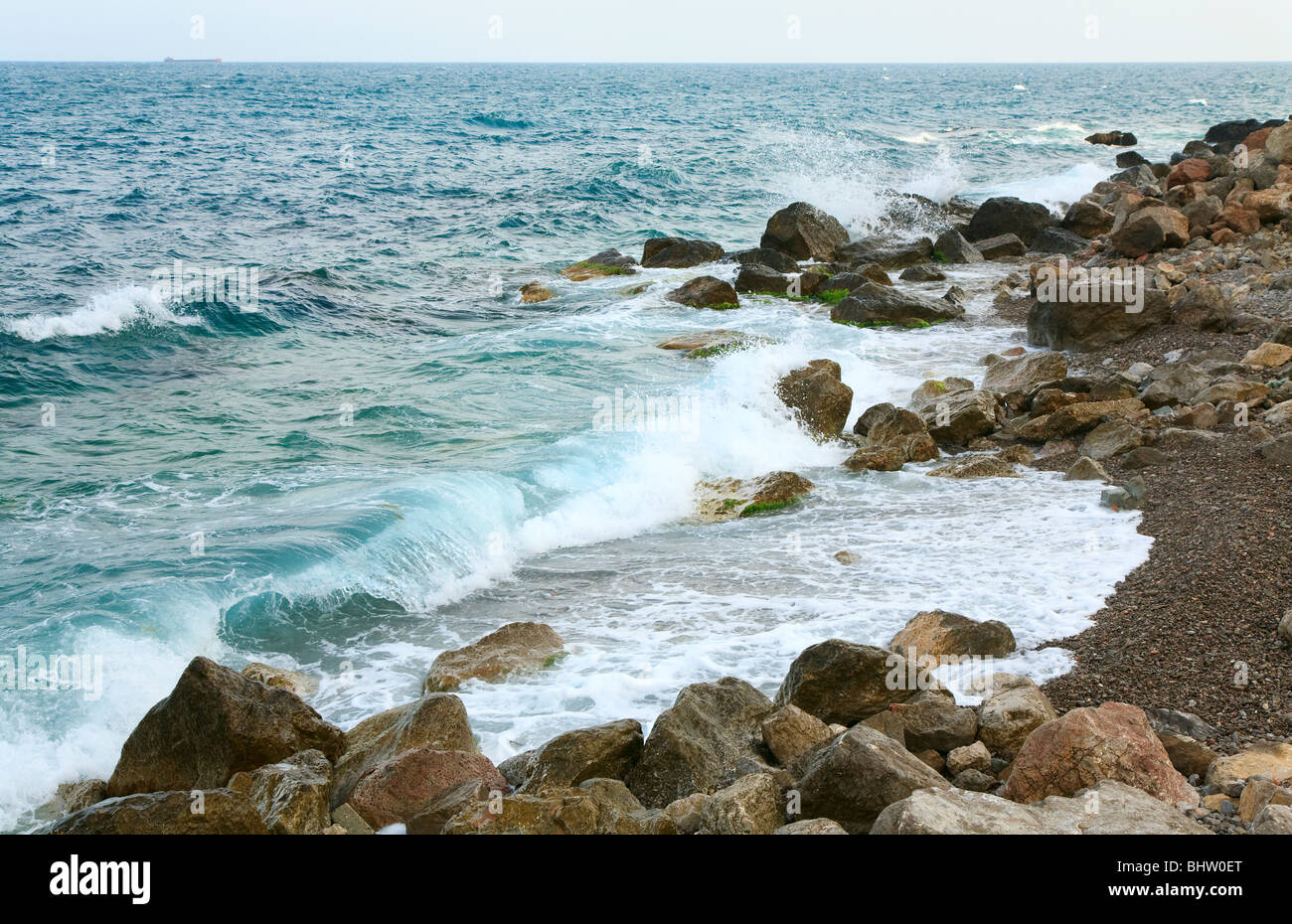 Stony sea coastline and wave with splashes Stock Photo - Alamy