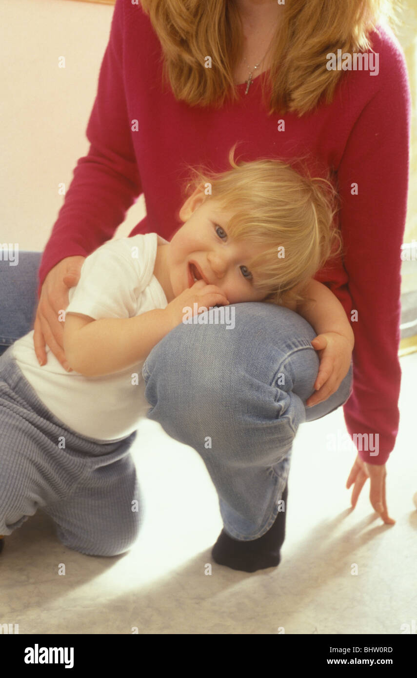 baby of nine months clinging to his mother and looking shy Stock Photo ...