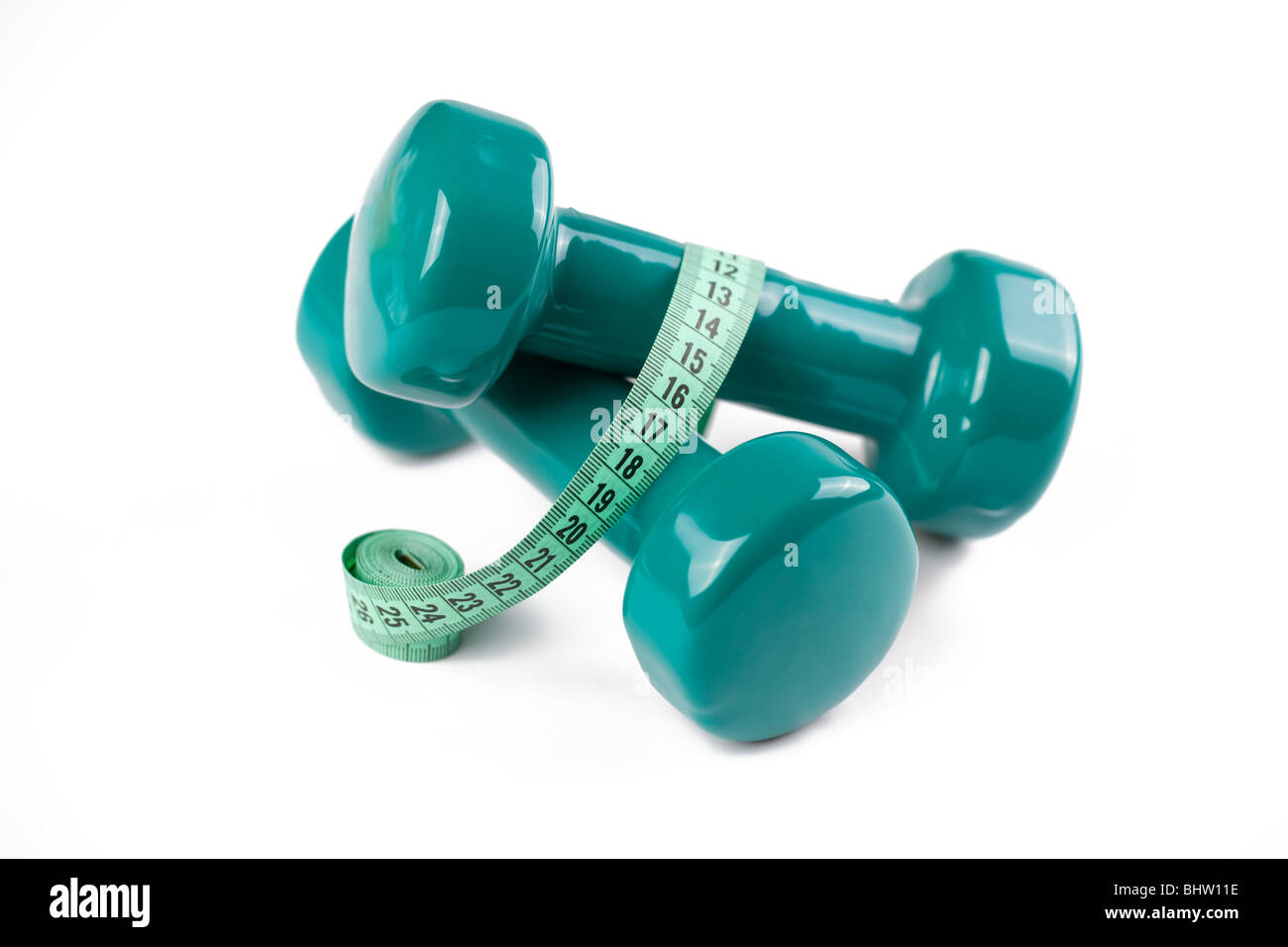 the green dumbell with measuring tape on white background Stock Photo ...