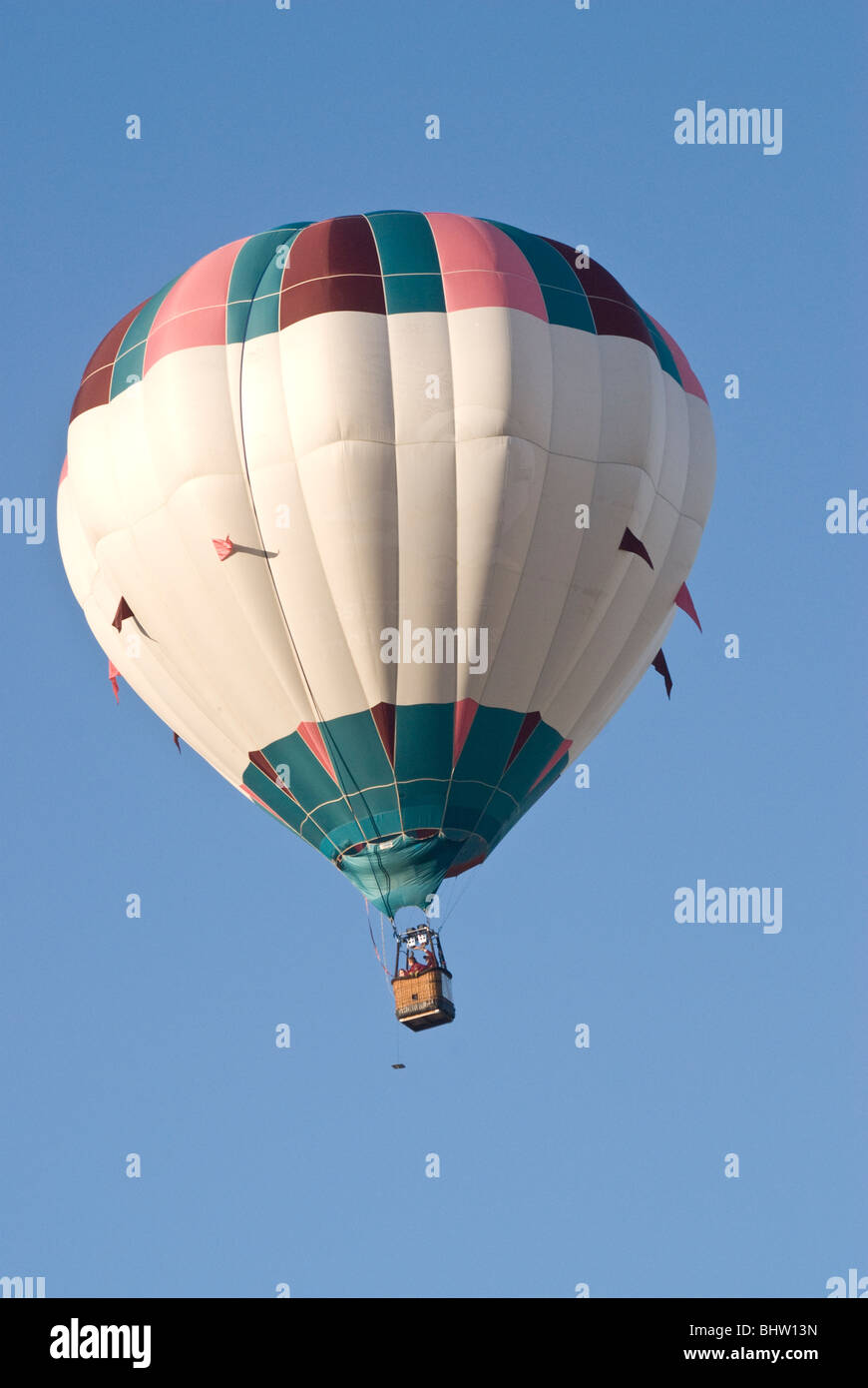 Hot air balloon flying up in a clear blue sky Stock Photo - Alamy