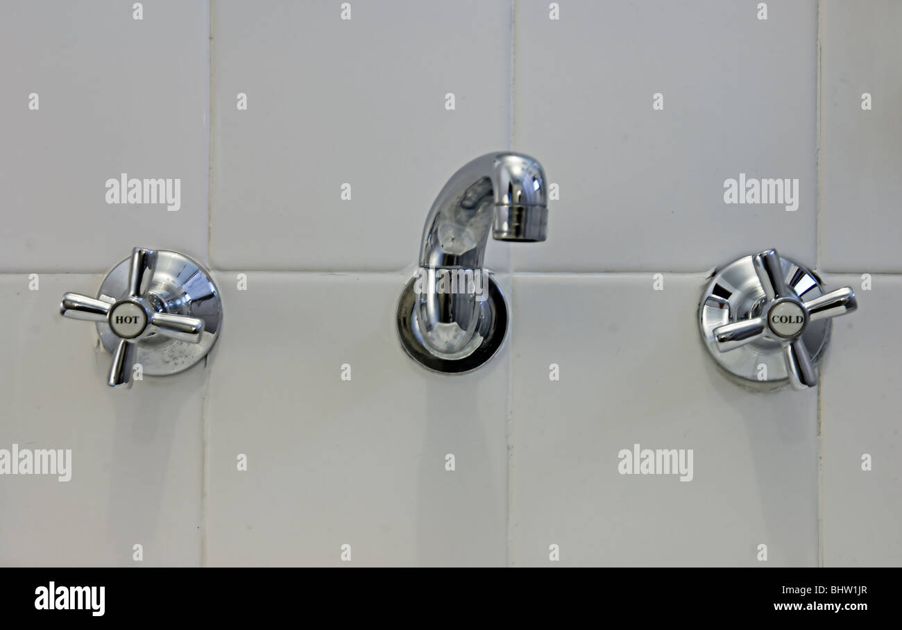 Taps in a bathroom showing hot and cold labels Stock Photo - Alamy