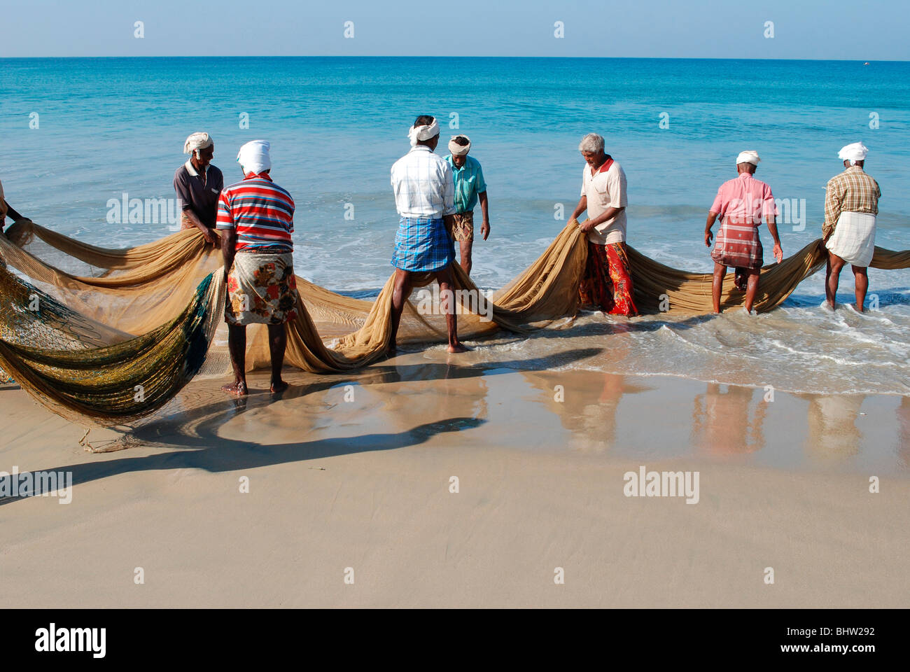 fishermen cathing fish in a beach in kerala ; india Stock Photo - Alamy