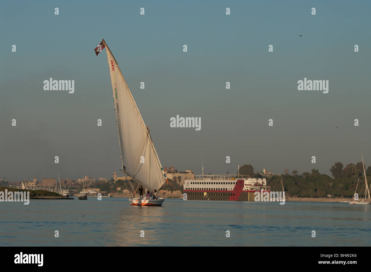 a felucca, traditional Nile boat makes its way down river at Luxor ...