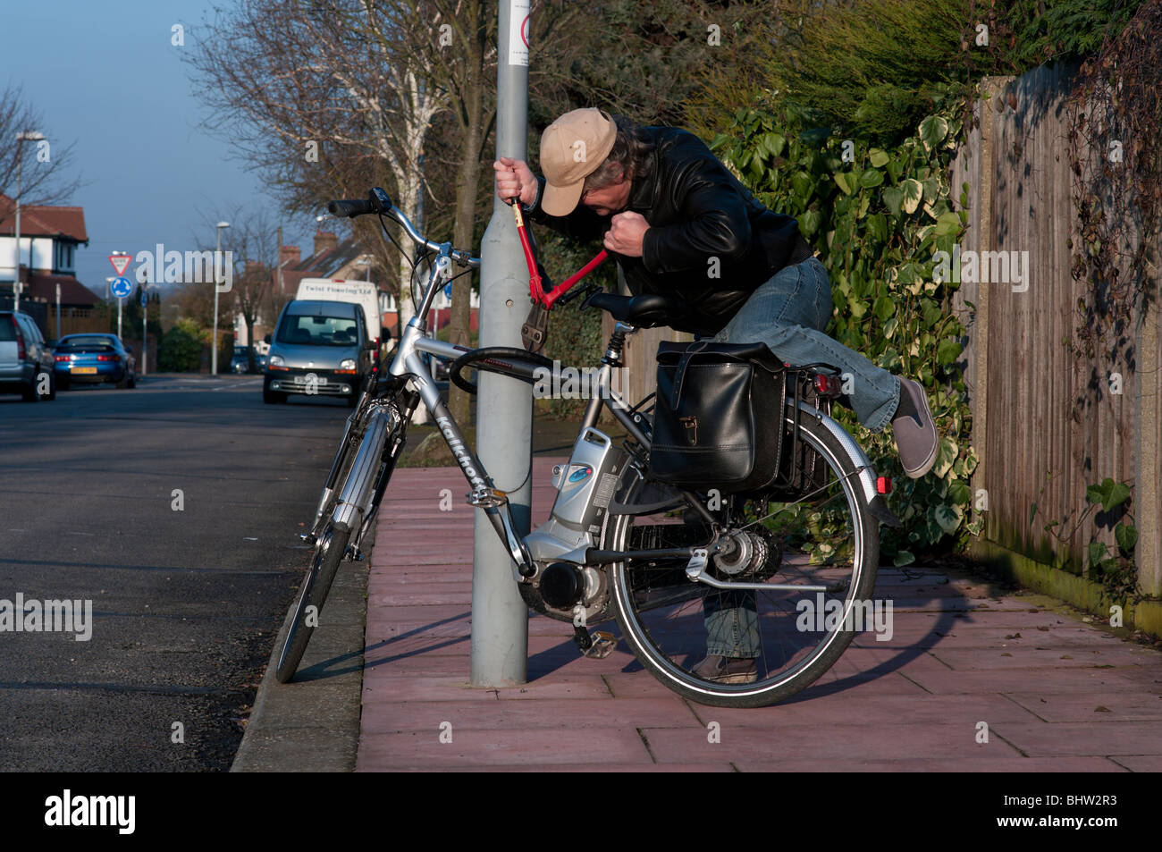 Bicycle thief takes wire cutters to steal chained up bike Stock Photo ...