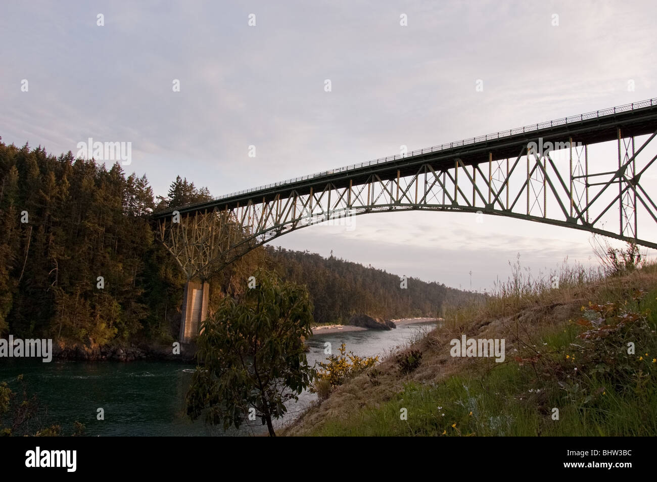 This bridge expands over a channel of water at sunset. Located at ...