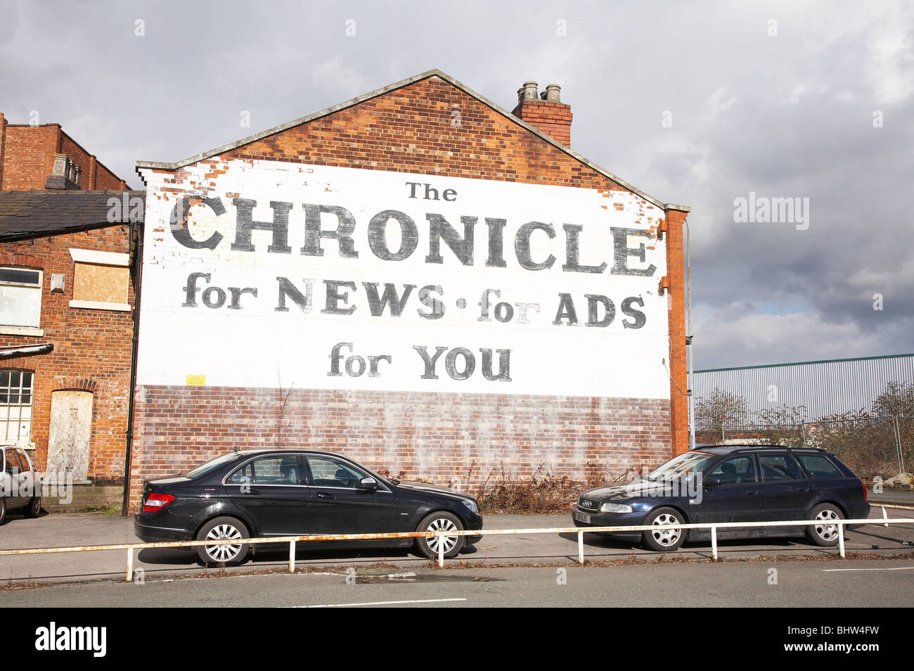 Painted advertisement for local newspaper painted on wall in Crewe UK ...