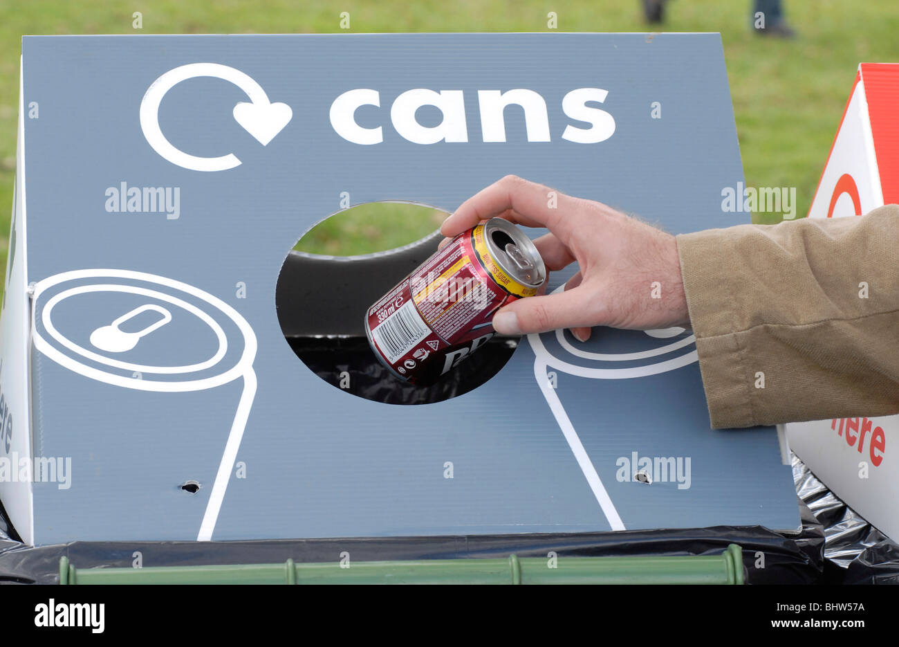 Using a Can recycling bin Stock Photo - Alamy