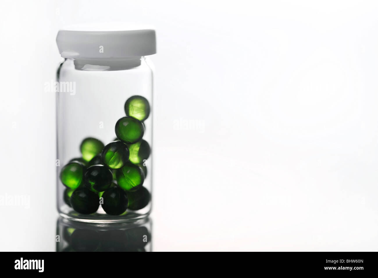 green gel capsules isolated on white background Stock Photo - Alamy