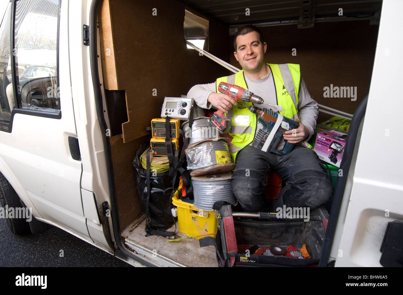 An electrician with the tools of his trade in his white van Stock Photo ...