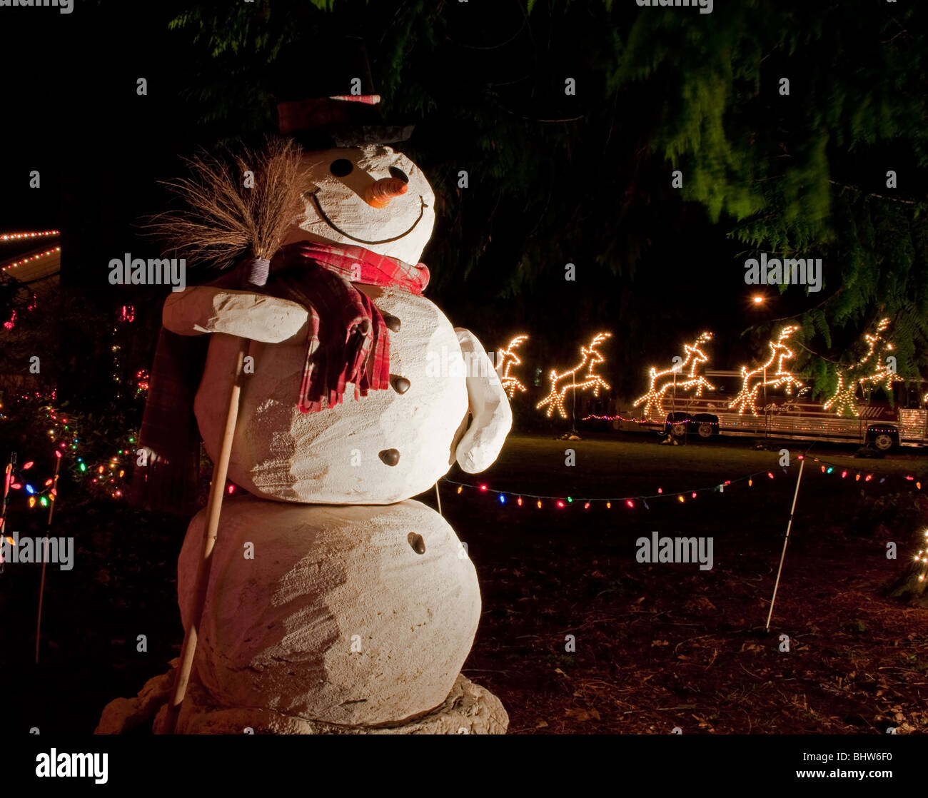 This dramatic night photo shows a fake snowman with a carrot nose and ...