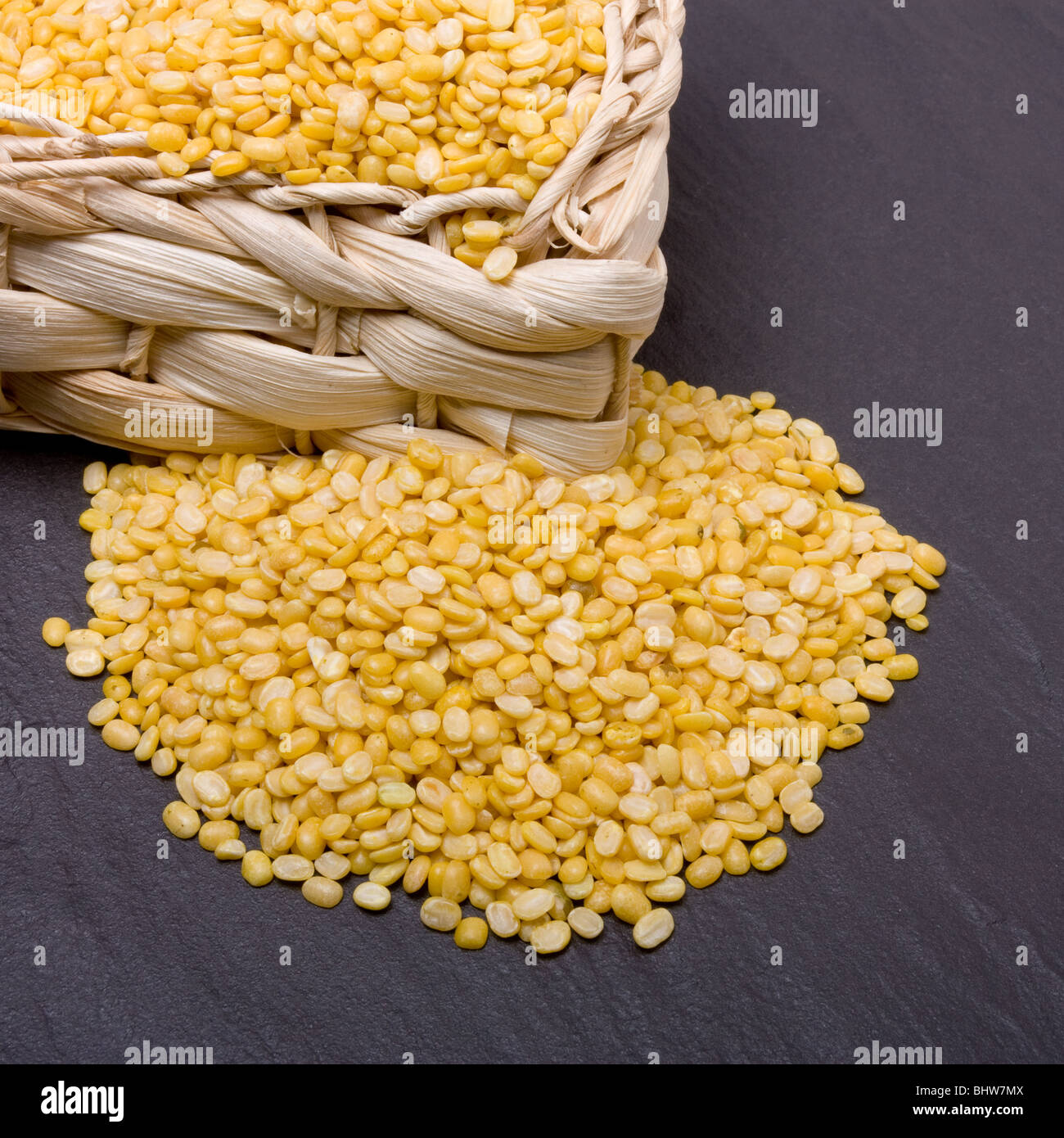 Vibrant yellow Moong Daal lentils or mung bean lentils against dark ...