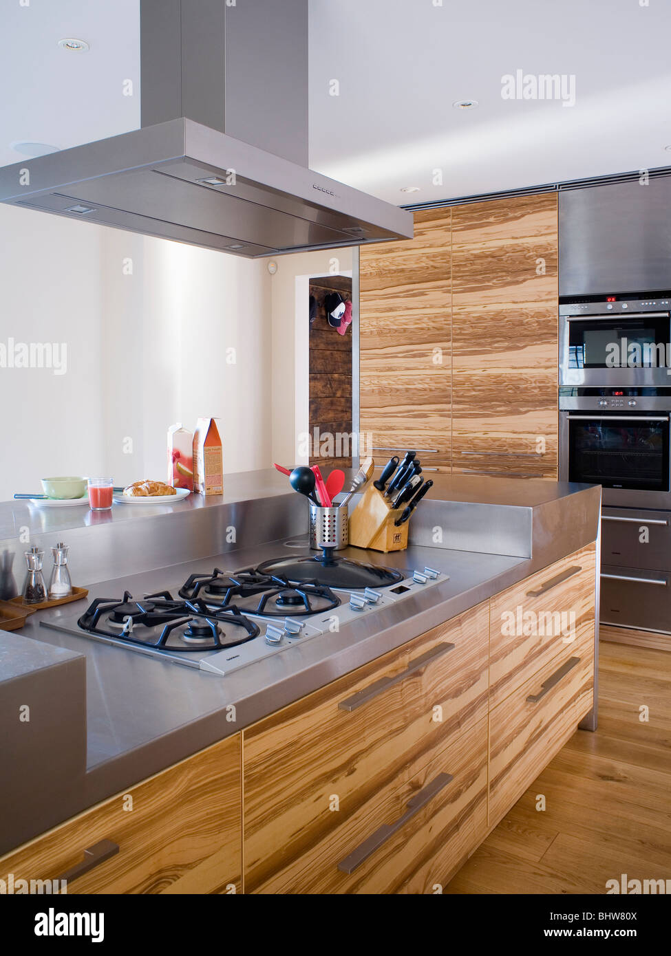 Extractor above hob in fitted unit with stainless steel worktop and ...