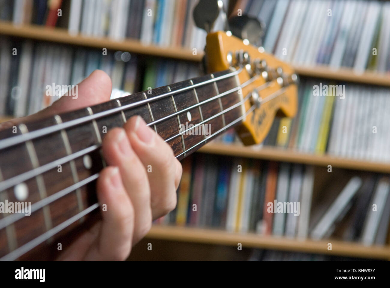 bass guitar fingers on fretboard Stock Photo - Alamy