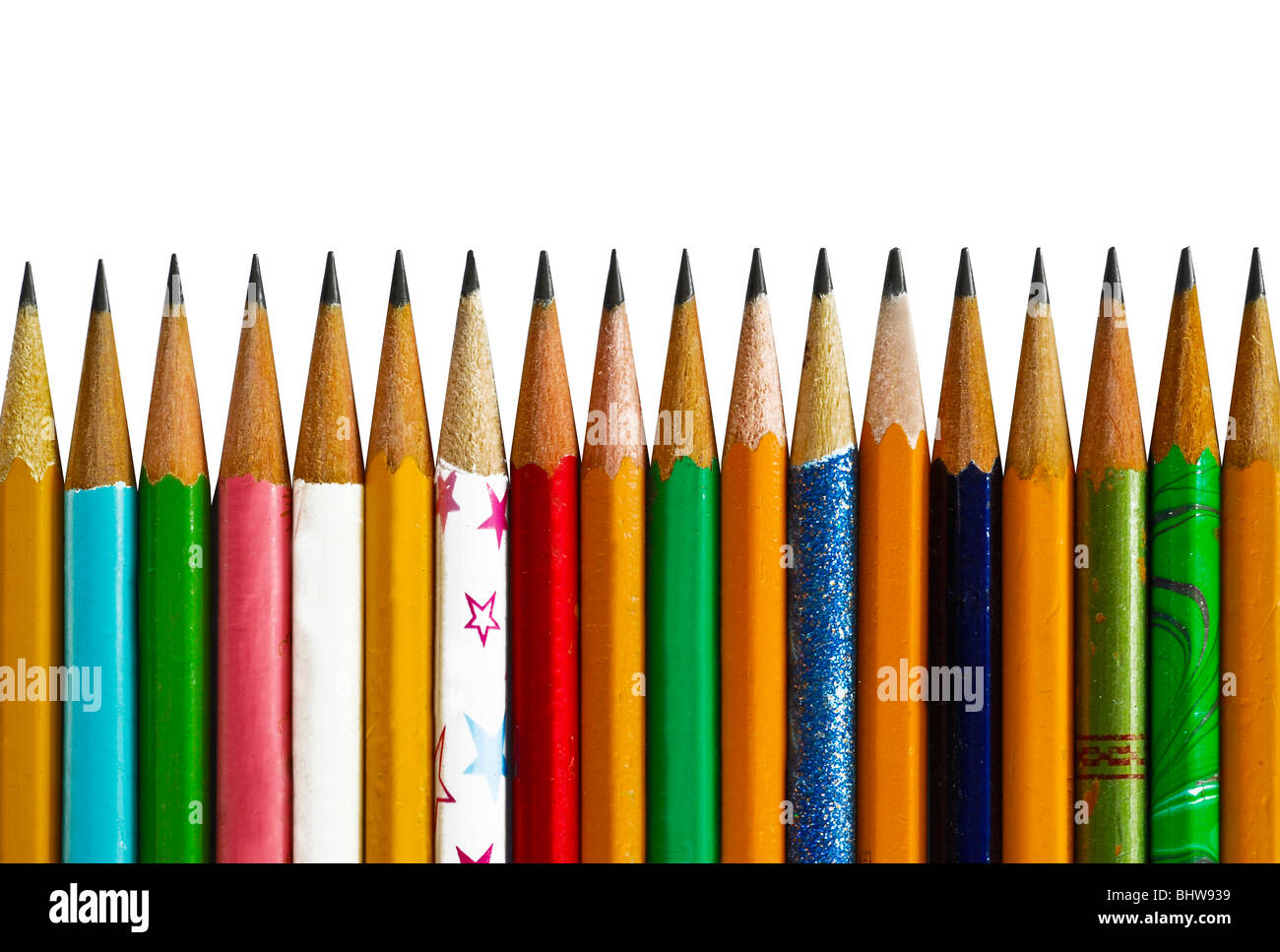 Multi-colored pencils in a row against white background Stock Photo - Alamy