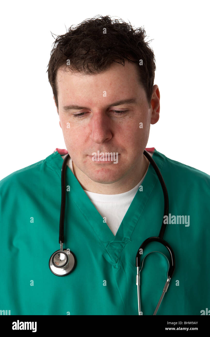 man wearing medical scrubs and stethoscope looking down looking sad ...