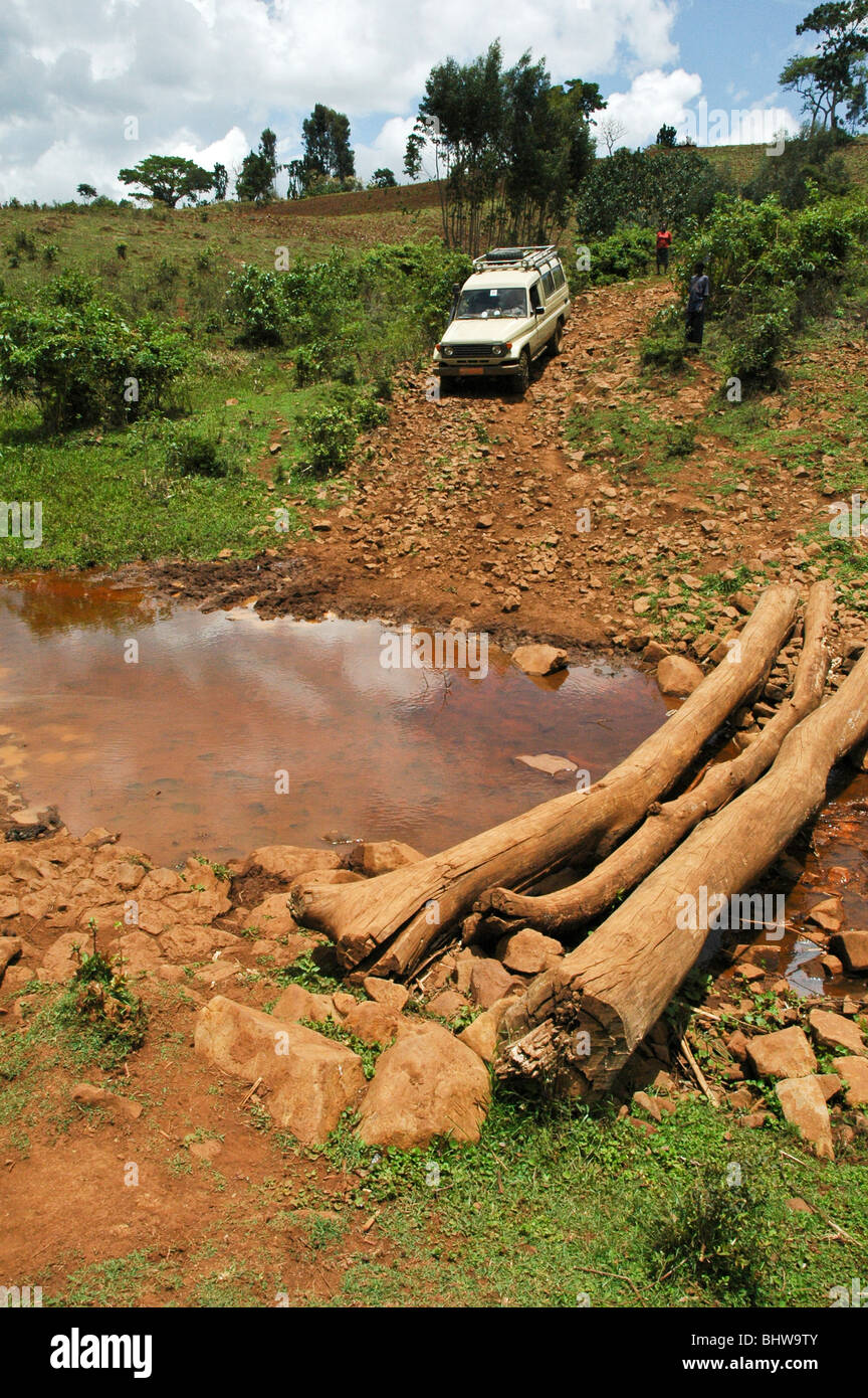 Vehicle descending rough road toward stream Stock Photo - Alamy