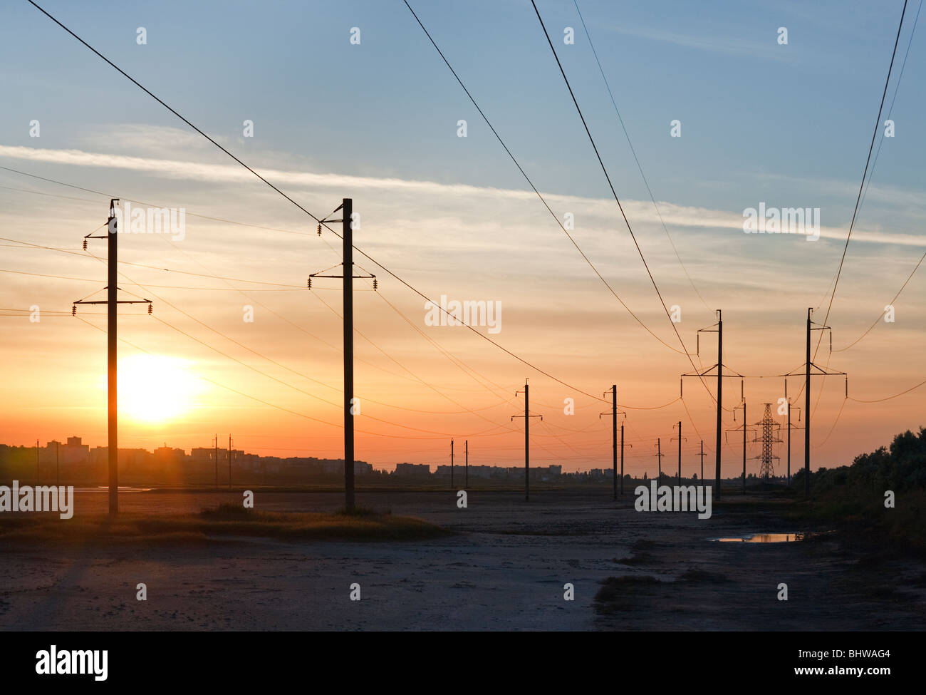 Sunset sky above the town and high-tension transmission line Stock ...