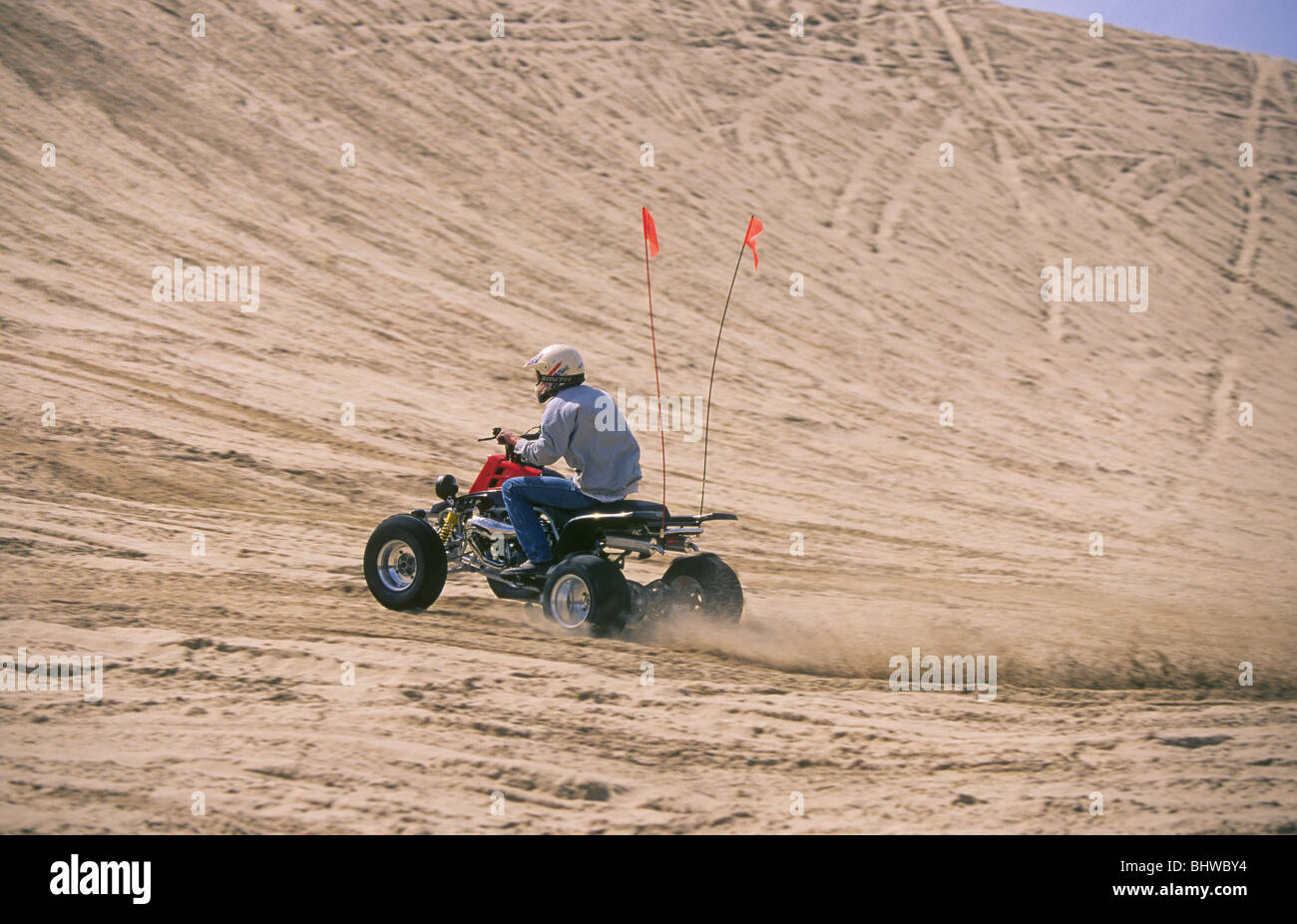 A man driving an ATV or All Terrain Vehicle speeds through the Oregon ...