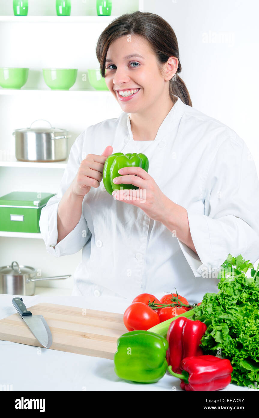 Woman Chef Inspecting A Green Pepper Stock Photo - Alamy